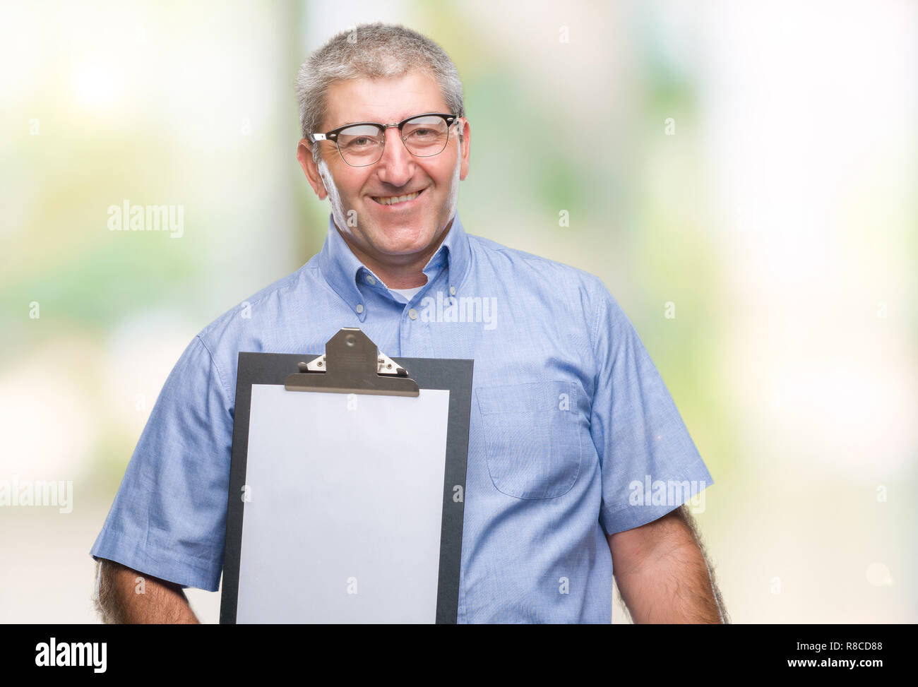 Handsome senior inspector man holding clipboard over isolated ...