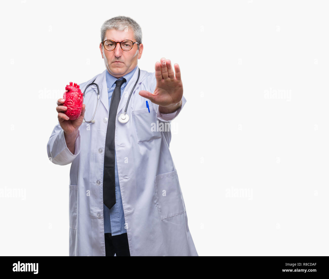 Handsome senior cardiologist doctor man holding heart over isolated ...