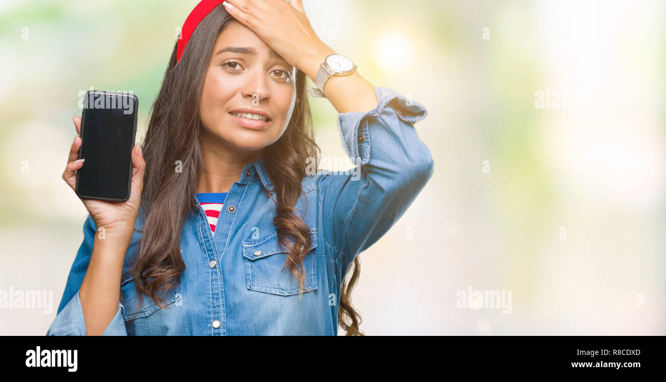 Young beautiful arab woman showing screen of smartphone over isolated ...