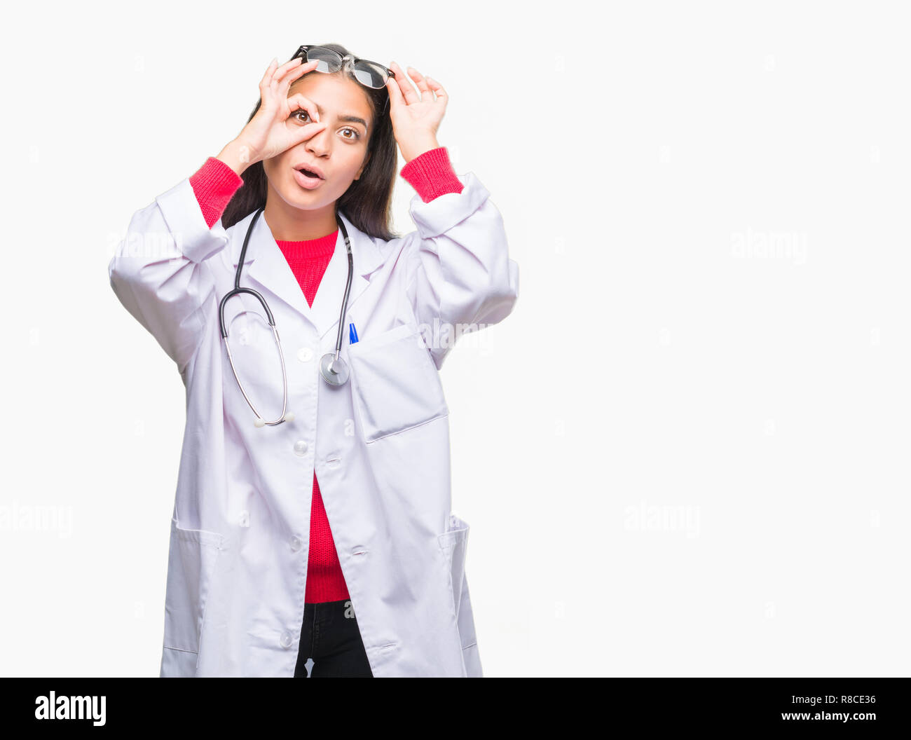 Young arab doctor woman over isolated background doing ok gesture ...