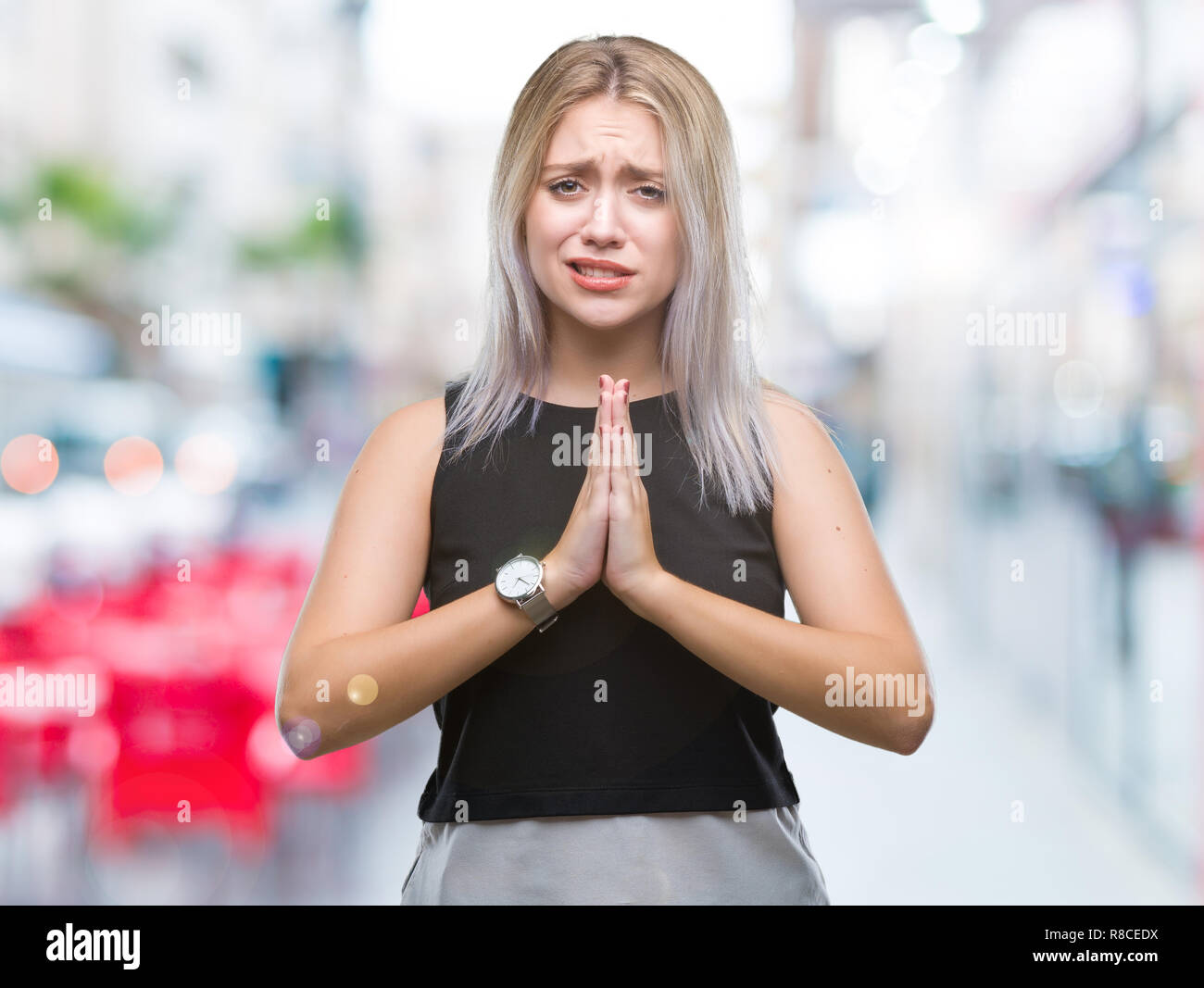 Young blonde woman over isolated background begging and praying with ...