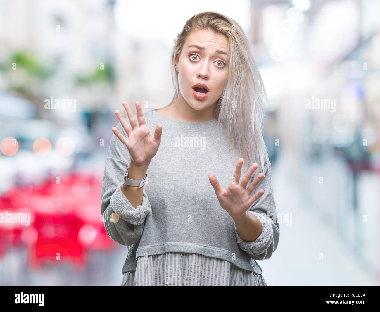 Young blonde woman over isolated background afraid and terrified with ...