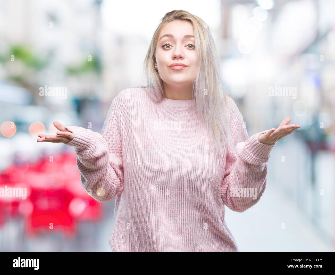 Young blonde woman wearing winter sweater over isolated background ...