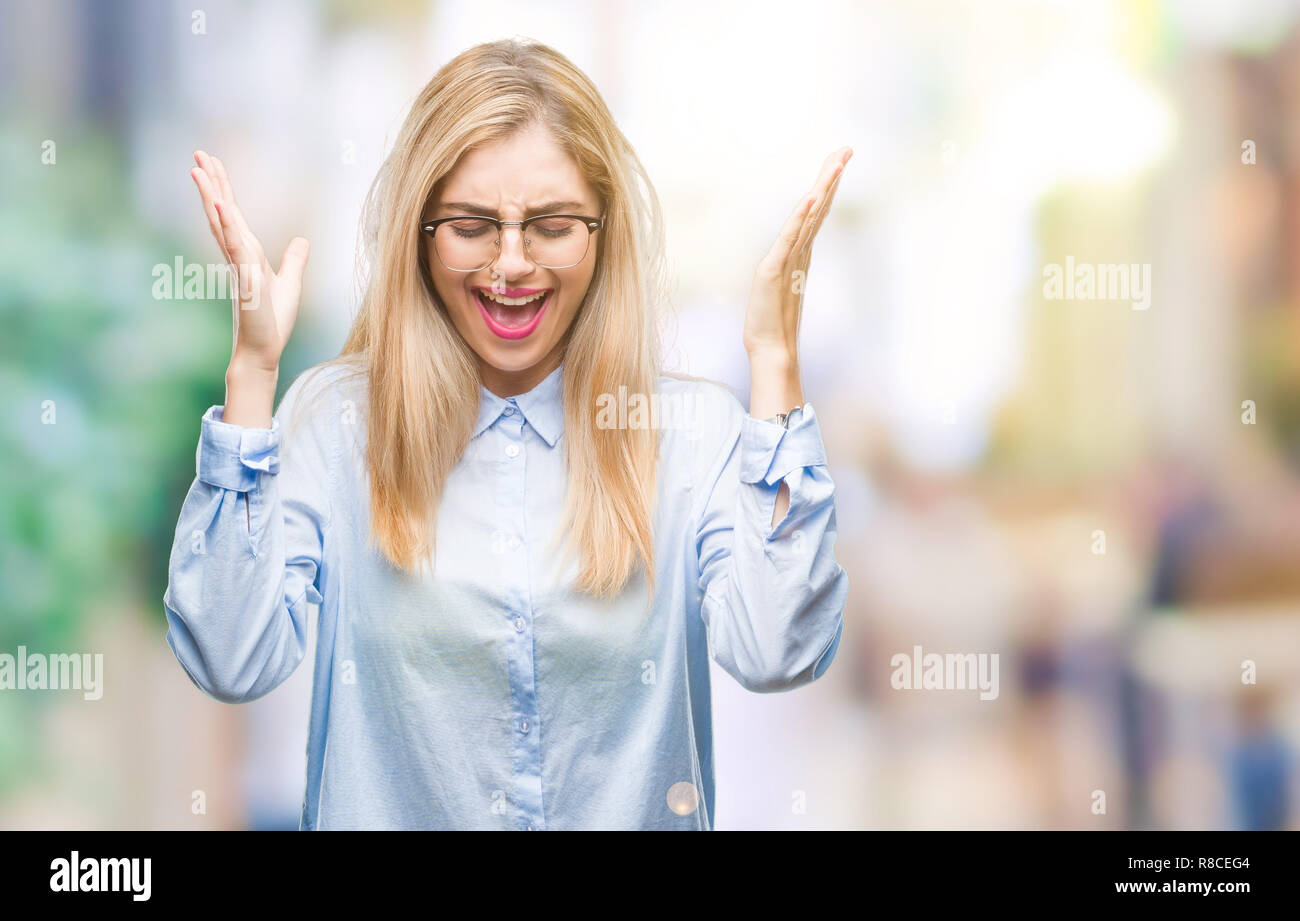 Young beautiful blonde business woman wearing glasses over isolated ...