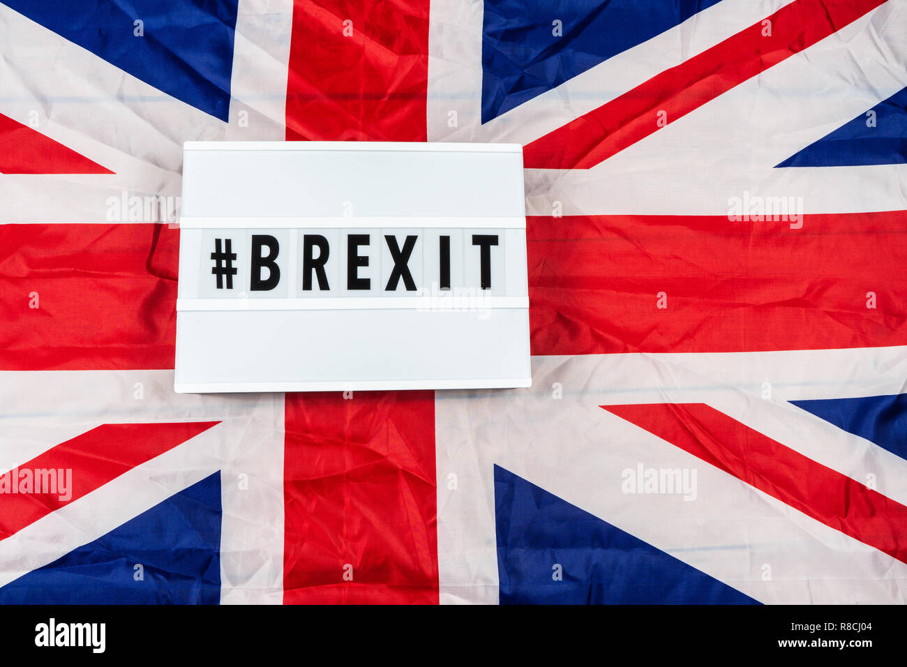 Brexit concept Union Jack and EU flag separated.Piggy coin bank on side ...