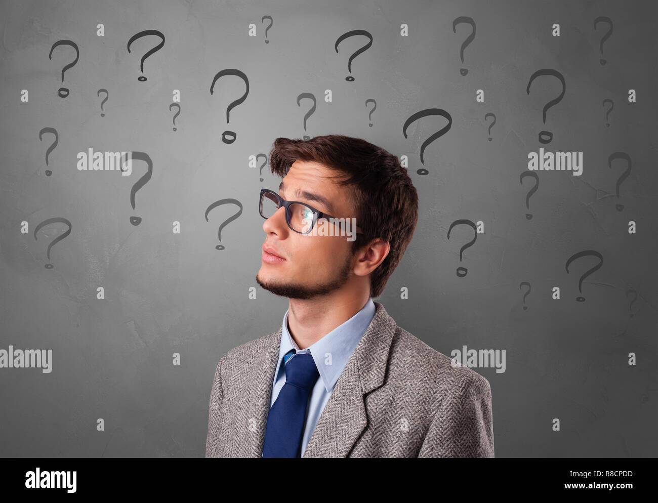 Person with question marks around face Stock Photo - Alamy