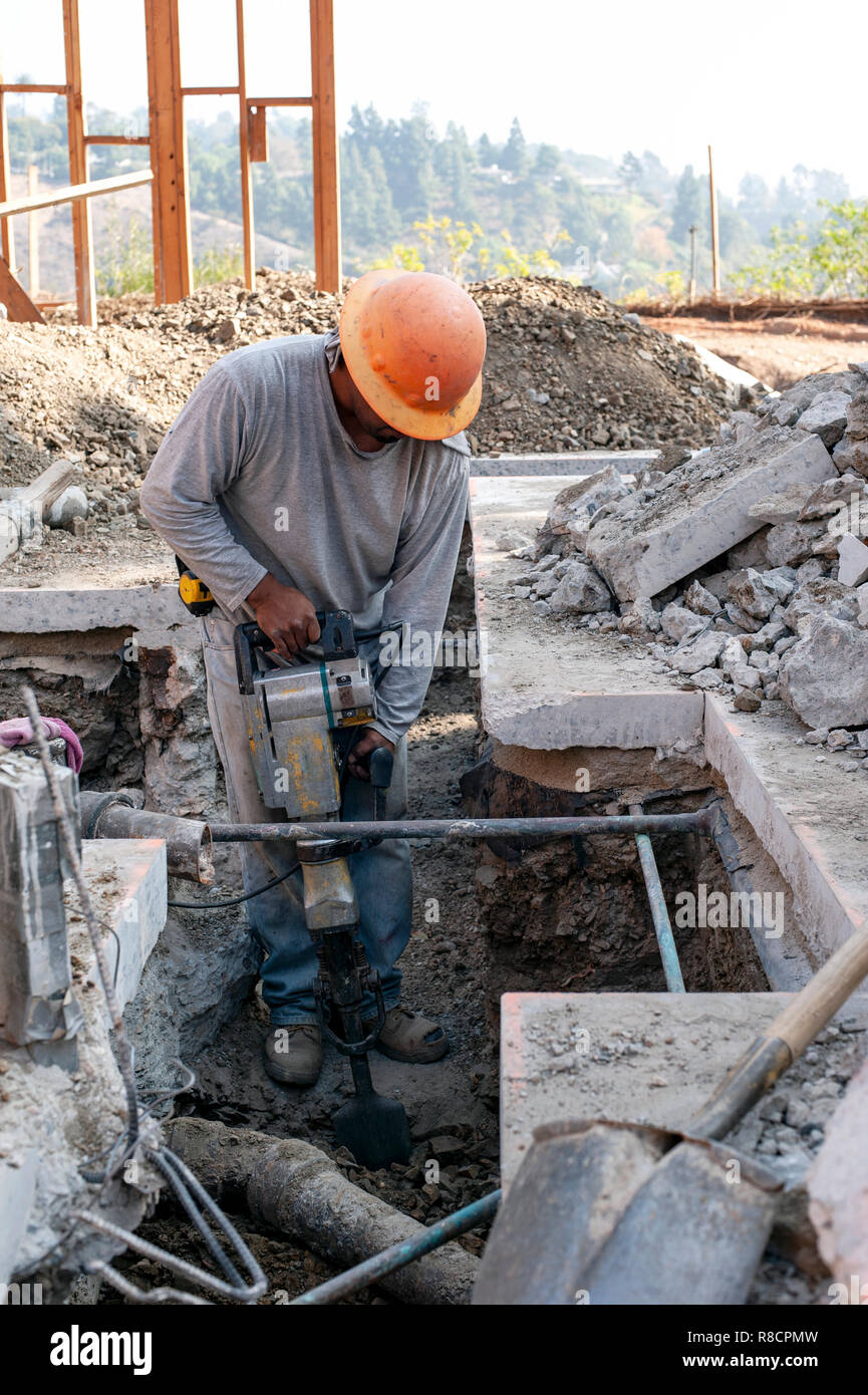 Working using a jackhammer to excavate a trench Stock Photo - Alamy