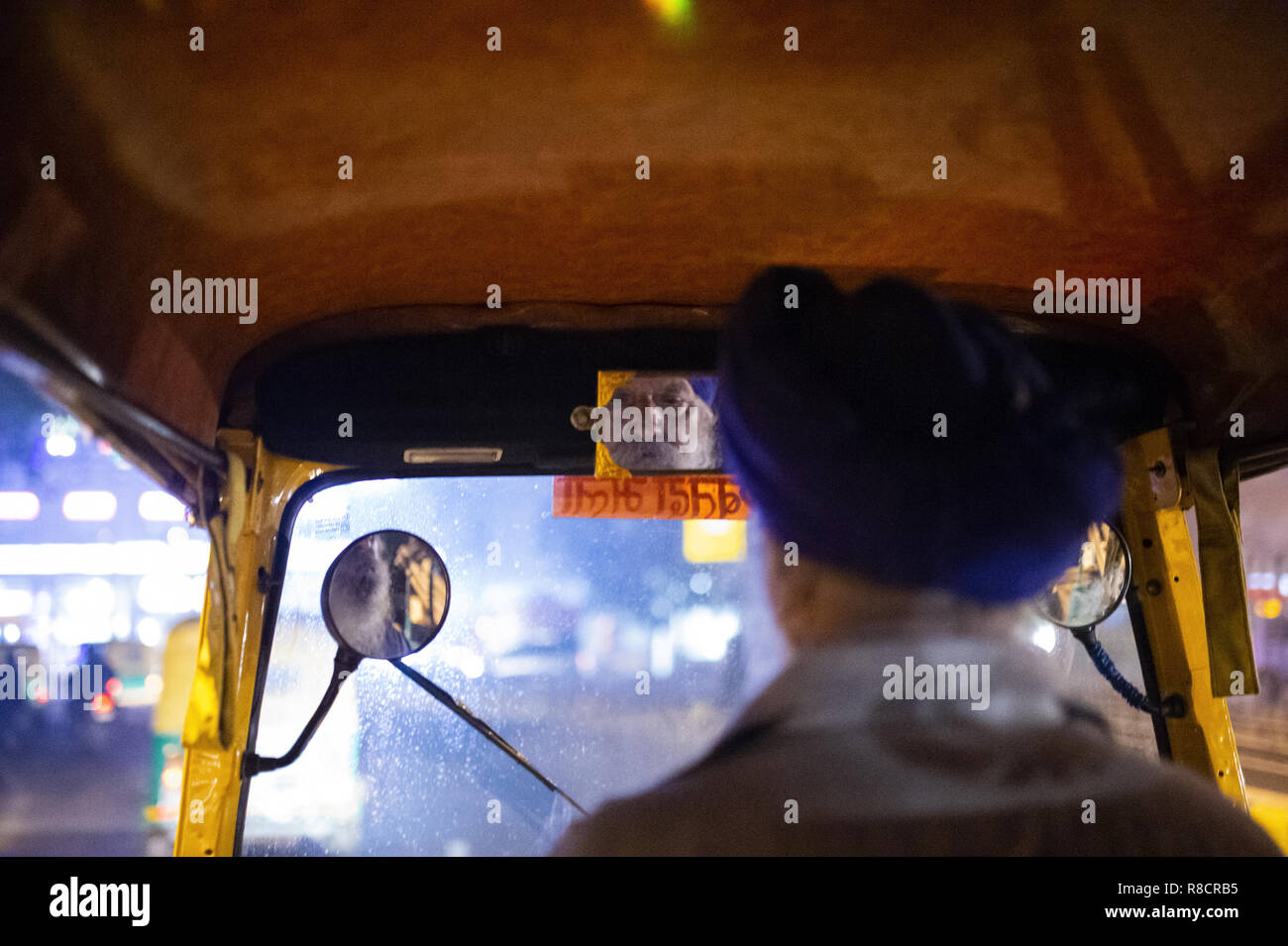 NEW DELHI - INDIA 1 DECEMBER 2018. An auto-rickshaw driver is driving ...