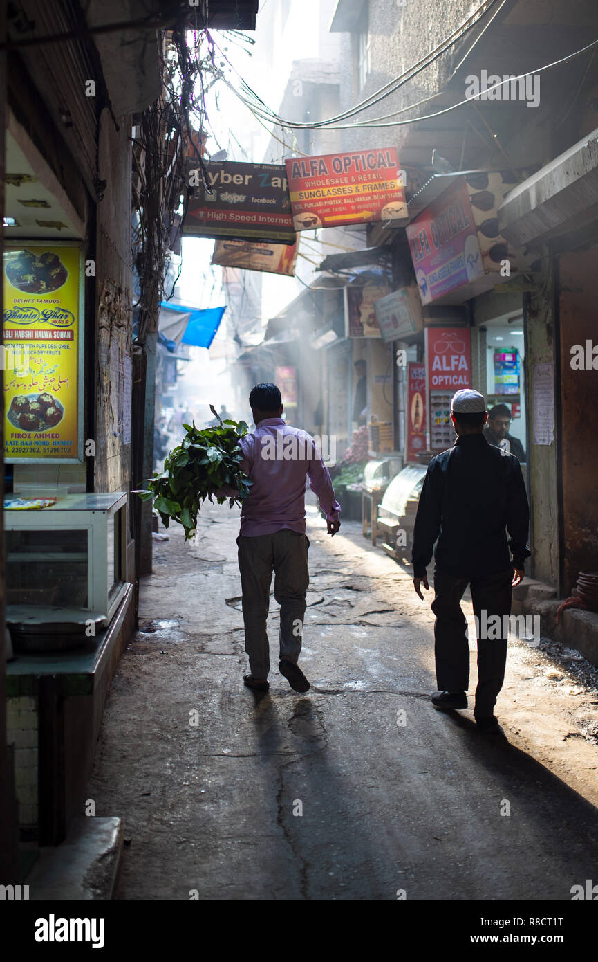 Daily life on the streets of Old Delhi at sunset. Old Delhi is a walled ...