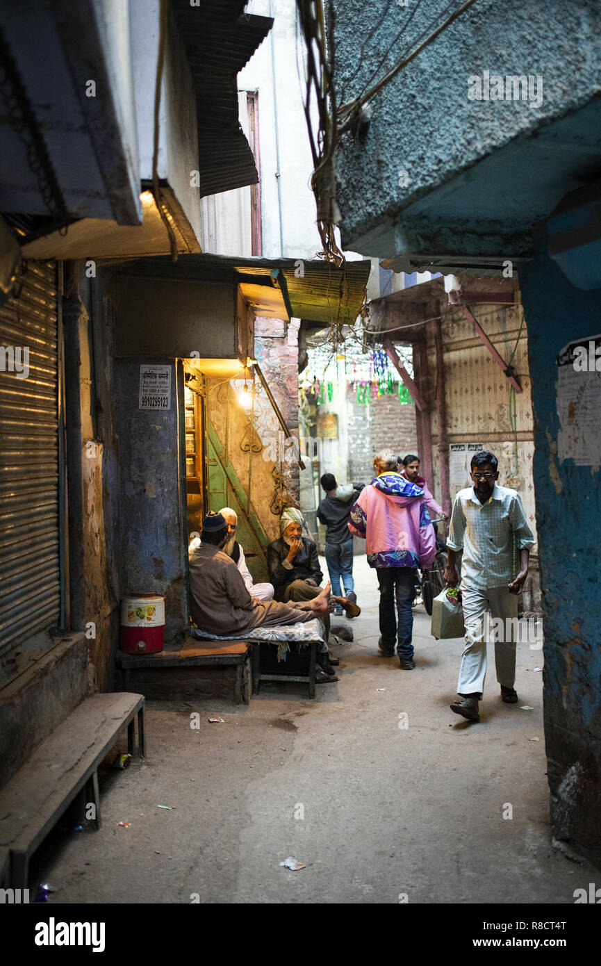 Daily life on the streets of Old Delhi at sunset. Old Delhi is a walled ...