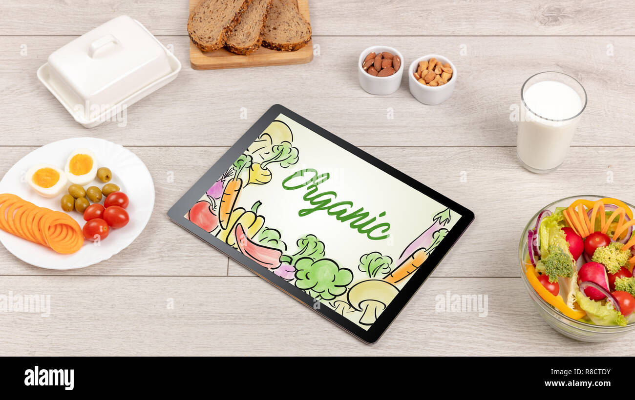 Healthy food composition with tablet Stock Photo - Alamy