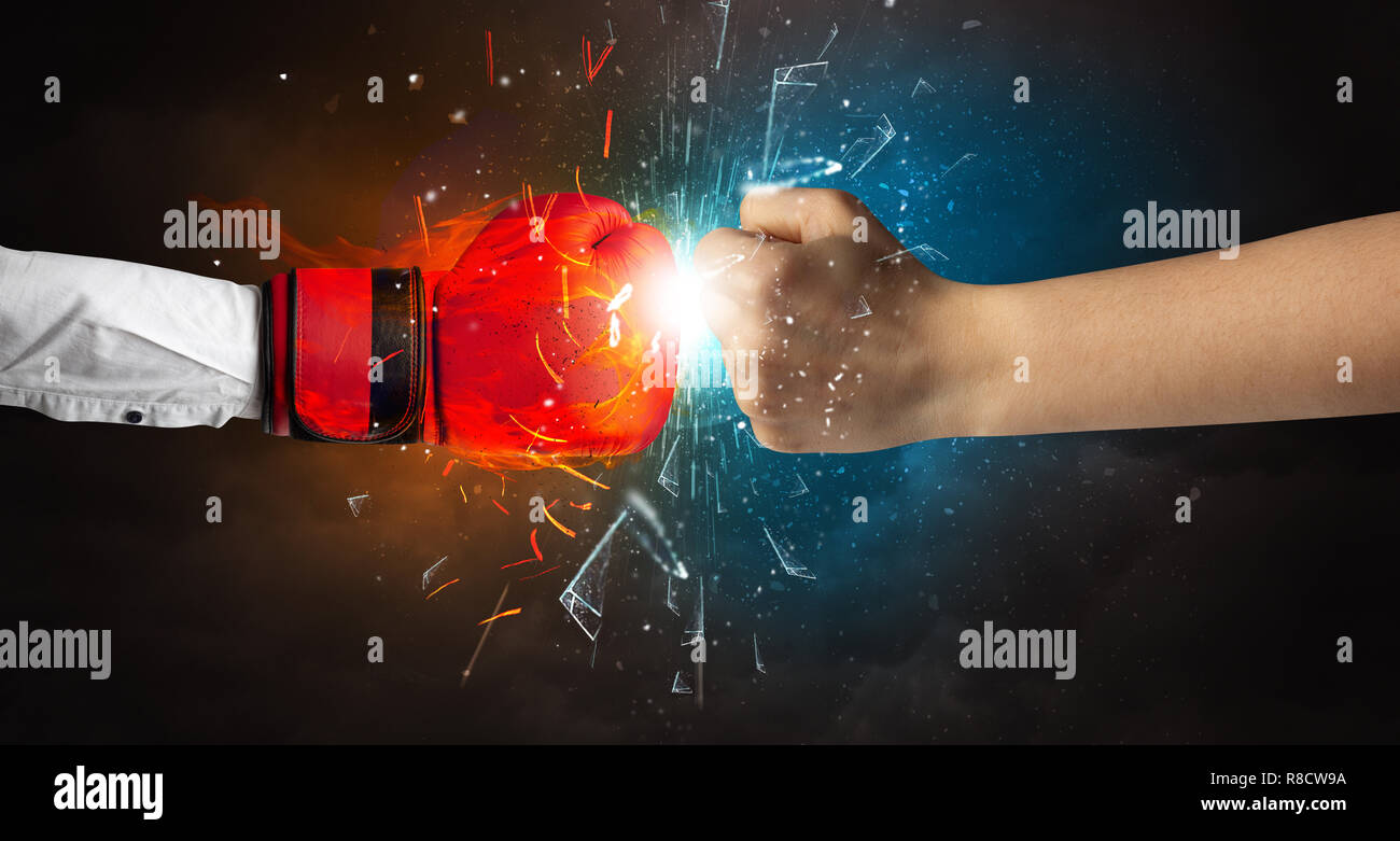 Two hands fighting and breaking glass into small pieces with fire and ...