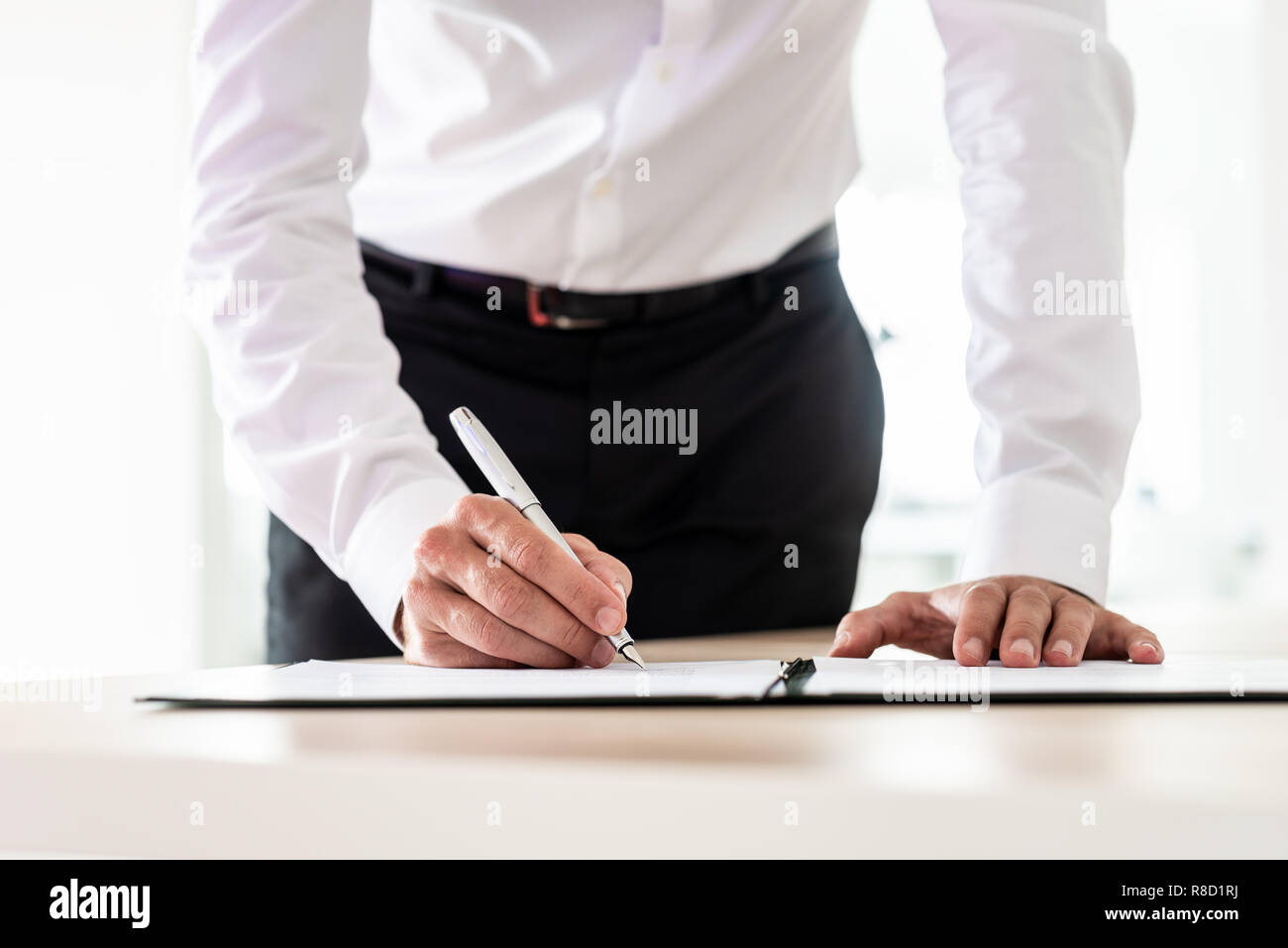 Lawyer signing an important document in a folder with an ink pen Stock ...