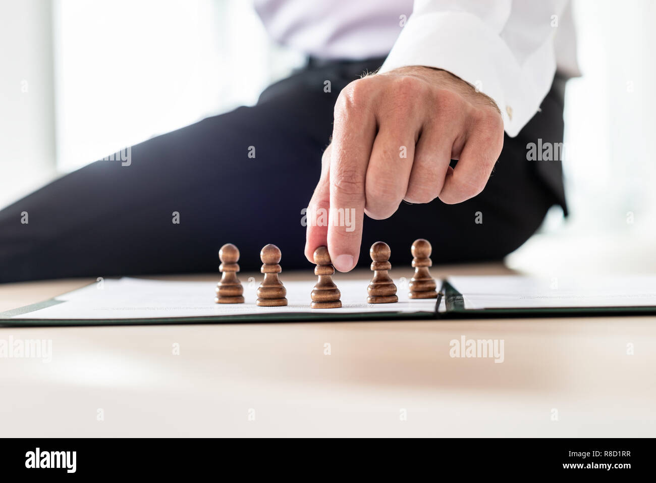 Business leader sitting on his desk making human resources decisions by ...
