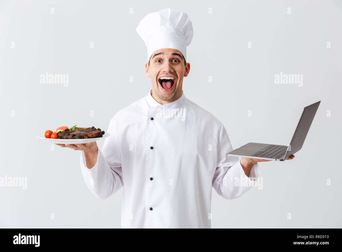 Excited chef cook wearing uniform standing over white background ...