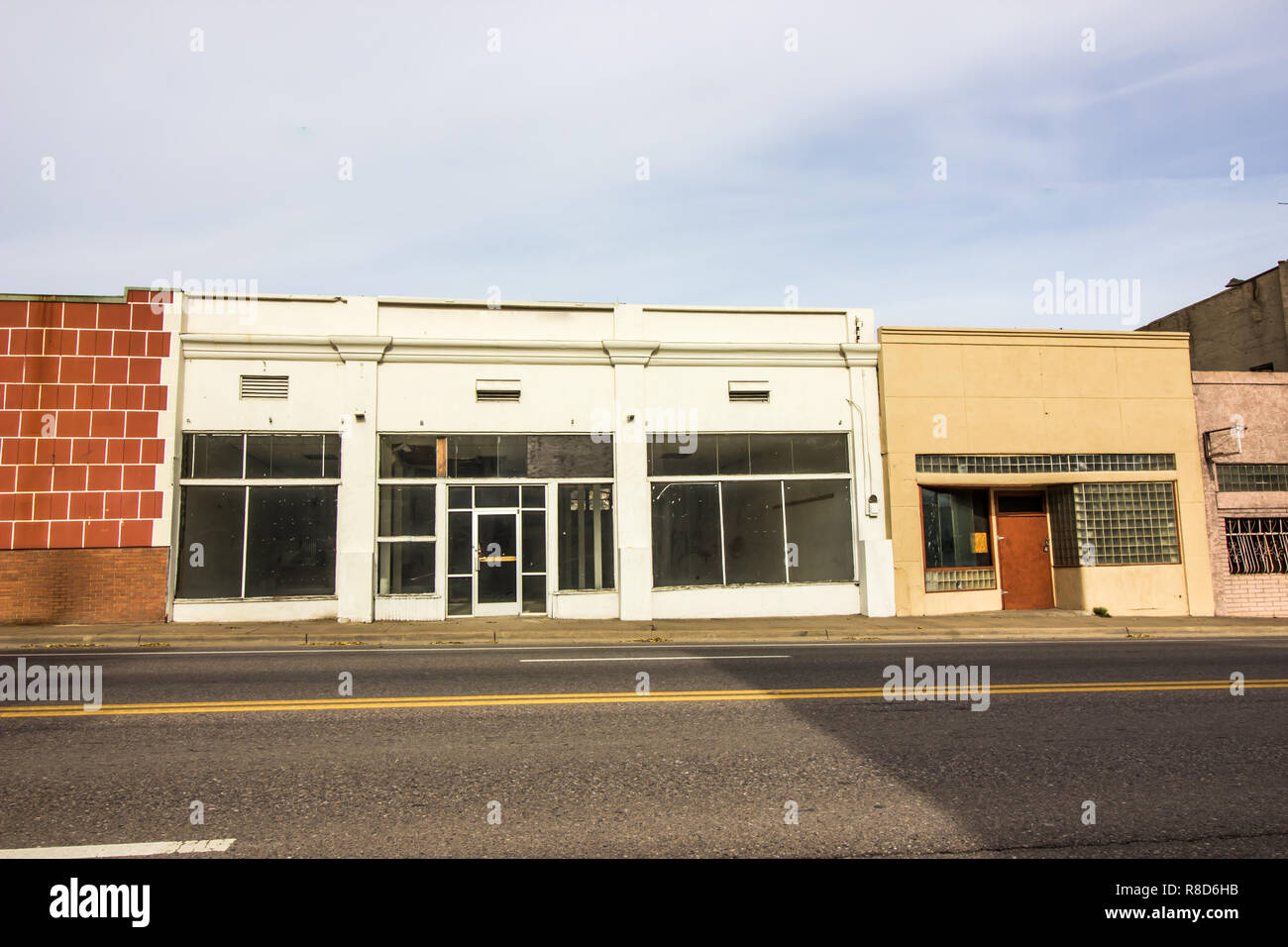 Vacant Commercial Storefront Buildings In Distressed Town Stock Photo vacant-commercial-storefront-buildings-in-distressed-town-stock-photo