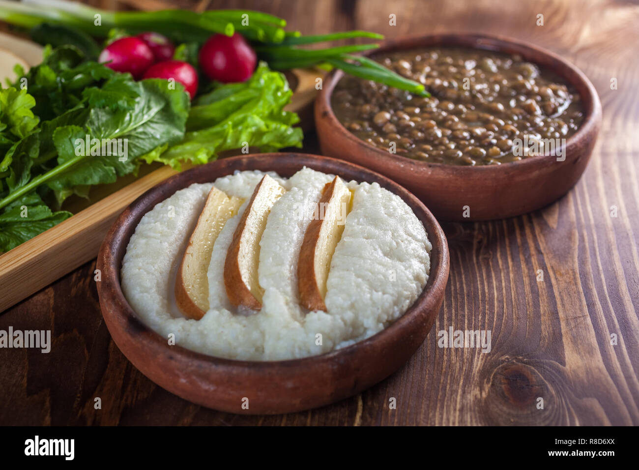 Mengrelian corn mamalica (ghomi) with cheese and lentls in ceramic dish ...