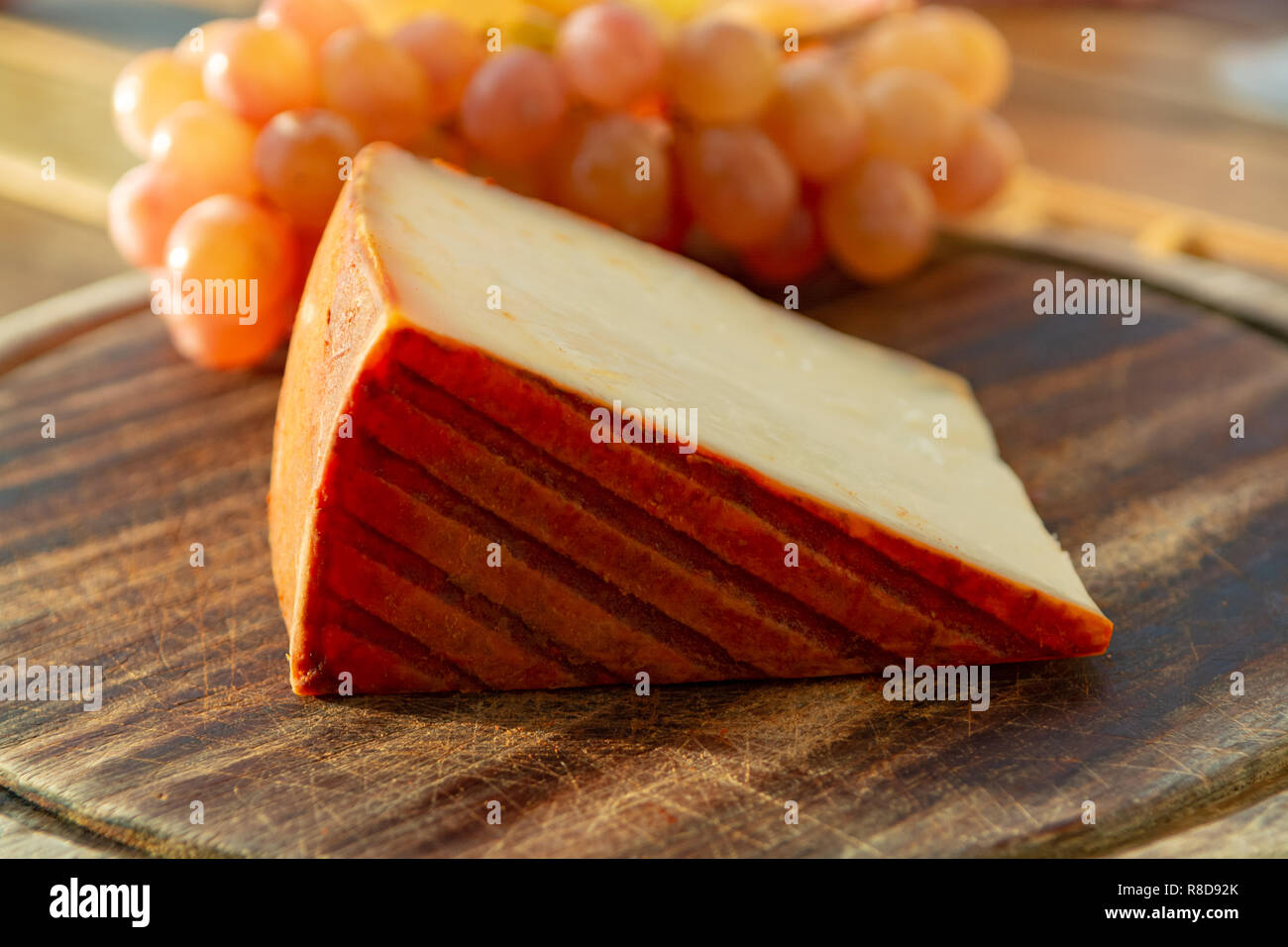 Spanish goat milk cheese with paprika coating and ripe pink table ...