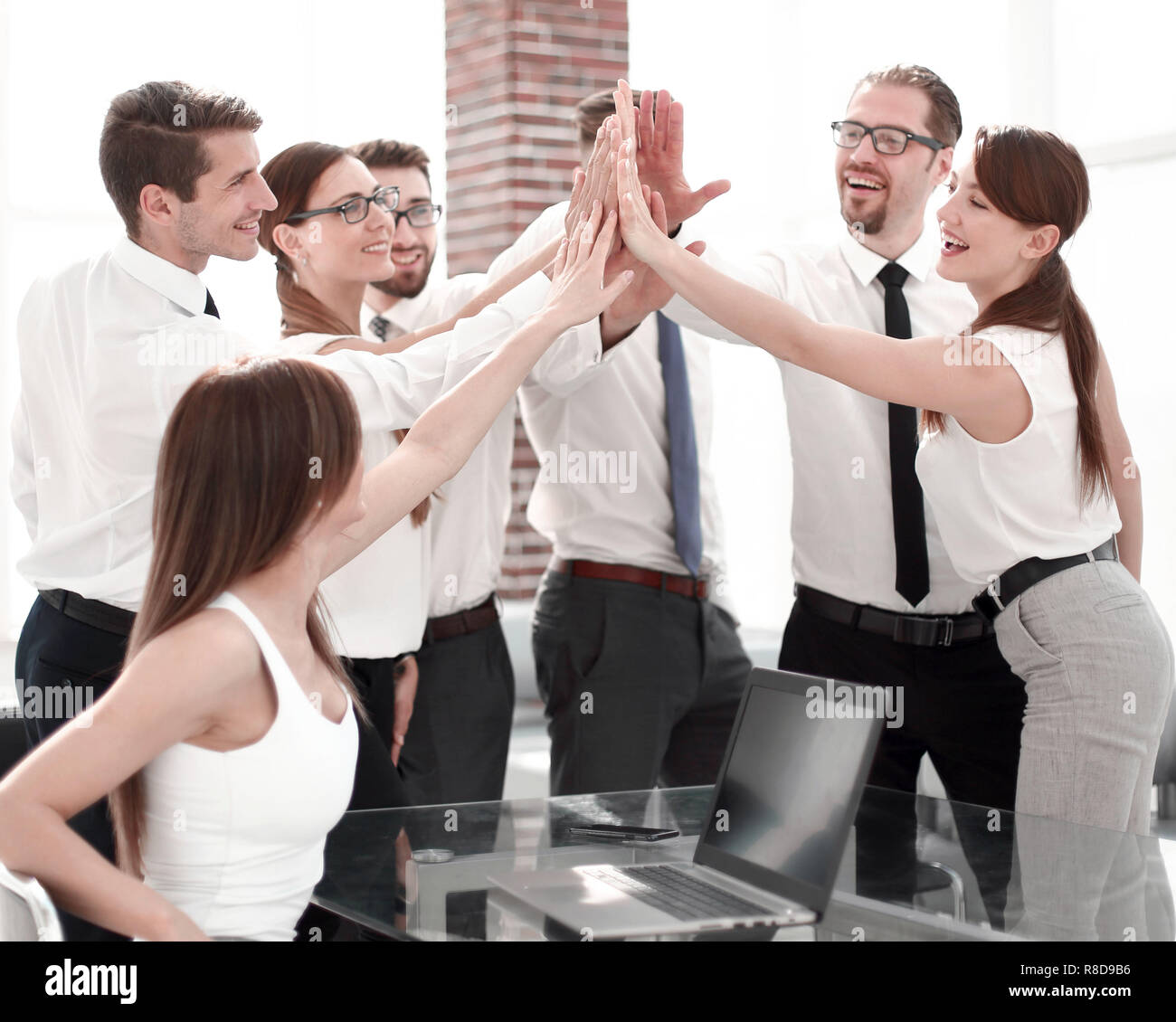 young business team giving each other high five Stock Photo - Alamy