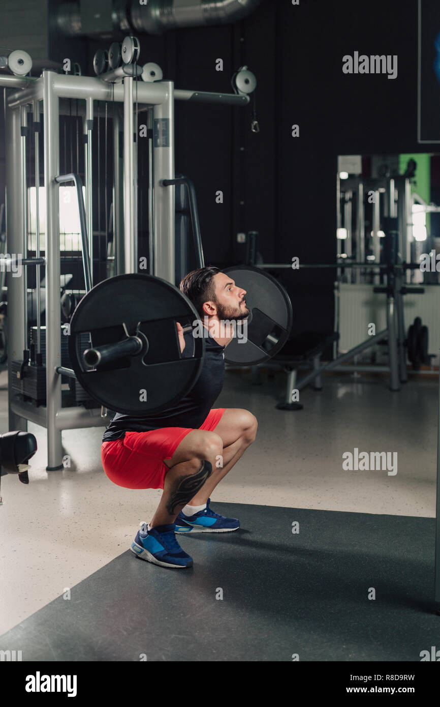 Strong man doing squat exercise hi-res stock photography and images - Alamy