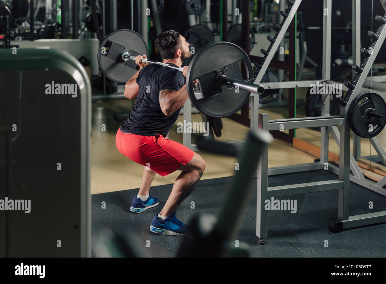Man gym squats barbell hi-res stock photography and images - Alamy