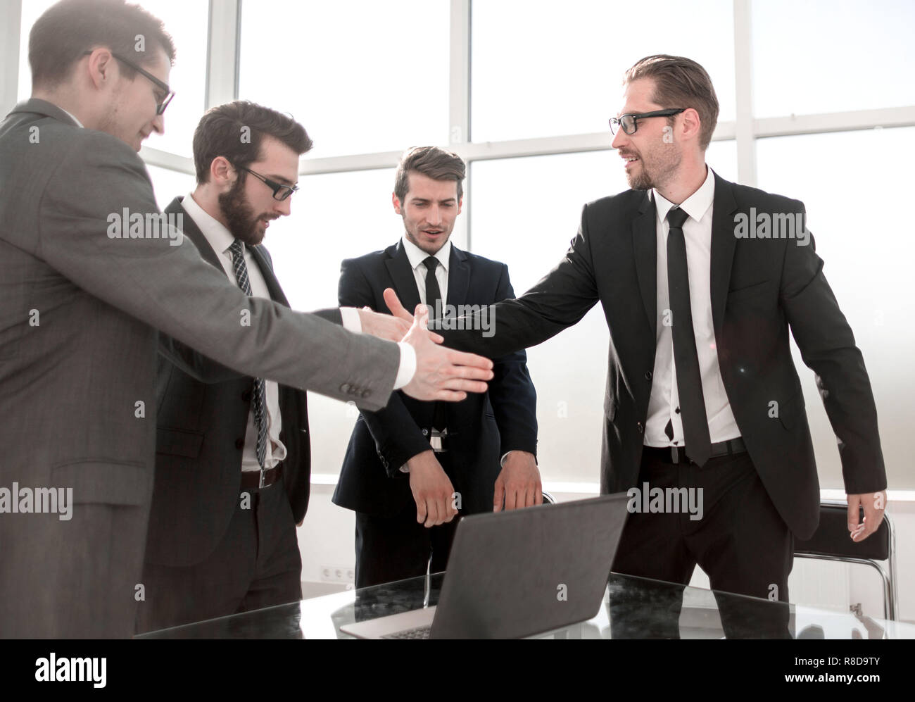 boss and employee shaking hands with each other Stock Photo - Alamy