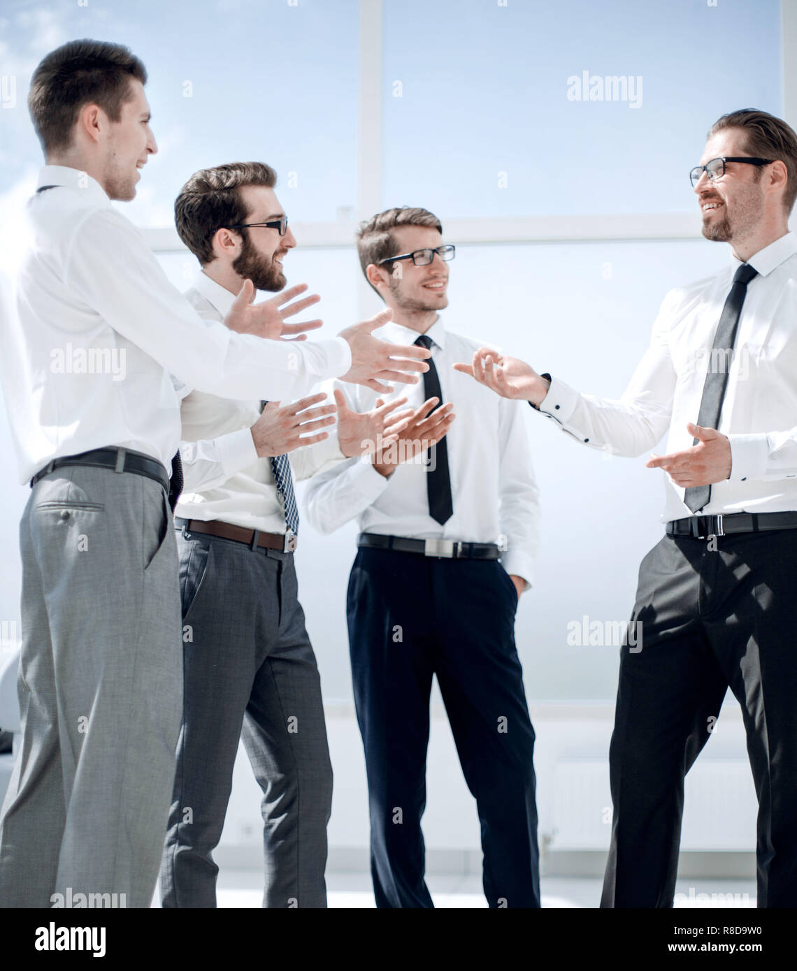 employees discussing their ideas standing in the office lobby Stock ...