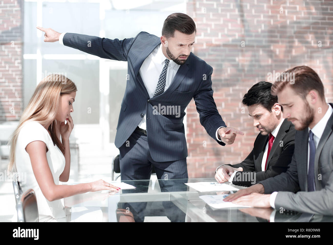 strict boss talking to employees at a business meeting Stock Photo - Alamy