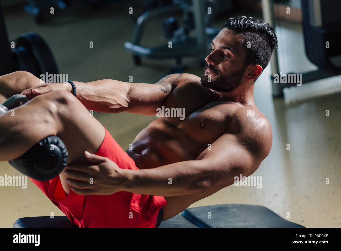Strong man in the gym doing abs exercises Stock Photo - Alamy