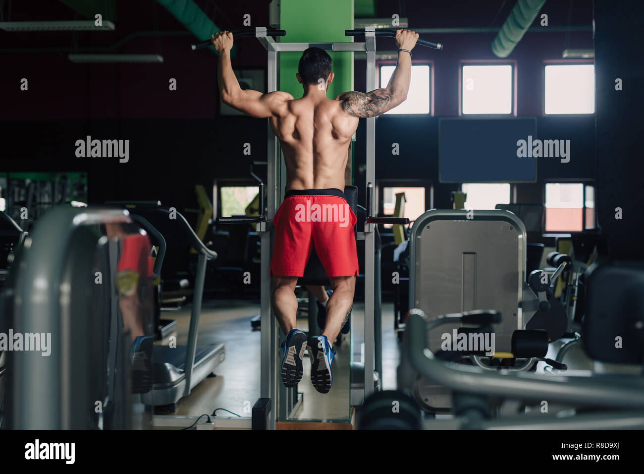 Strong man in the gym doing back exercise Stock Photo - Alamy