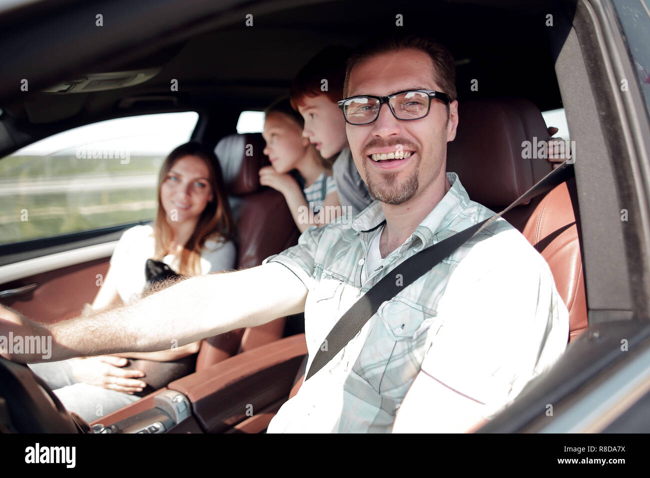 side view.happy father driving a car Stock Photo - Alamy