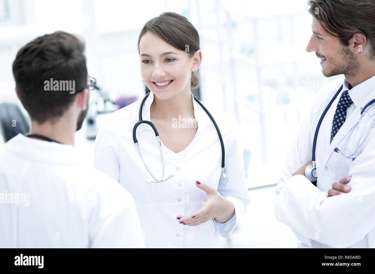 Team of different doctors having conversation Stock Photo - Alamy