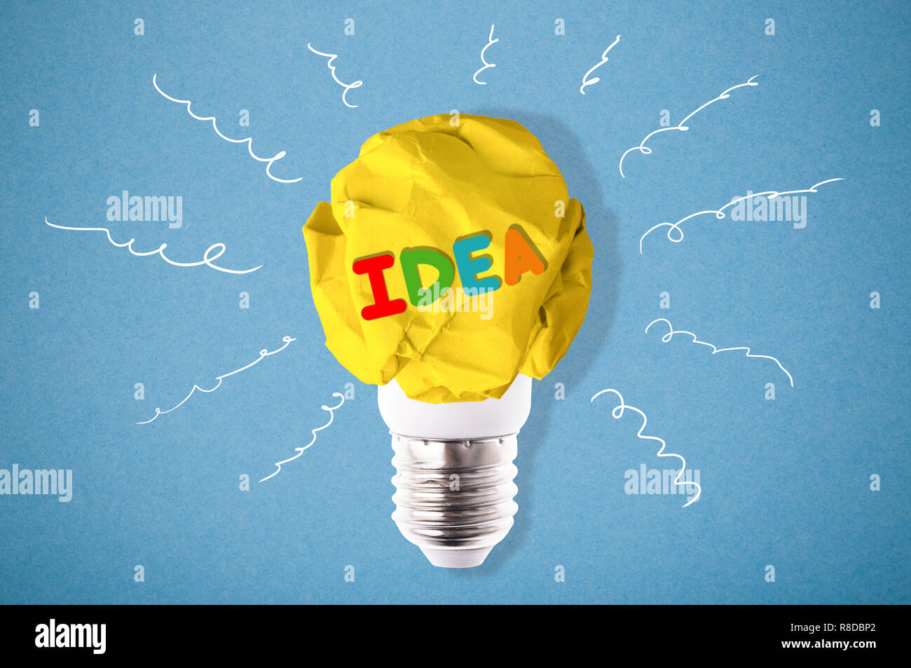 crumpled yellow paper light bulb with colorful inscription idea ...