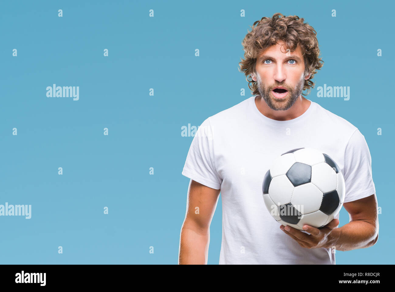 Handsome hispanic man model holding soccer football ball over isolated ...