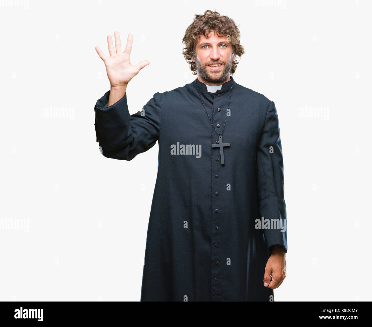 Handsome hispanic catholic priest man over isolated background showing ...