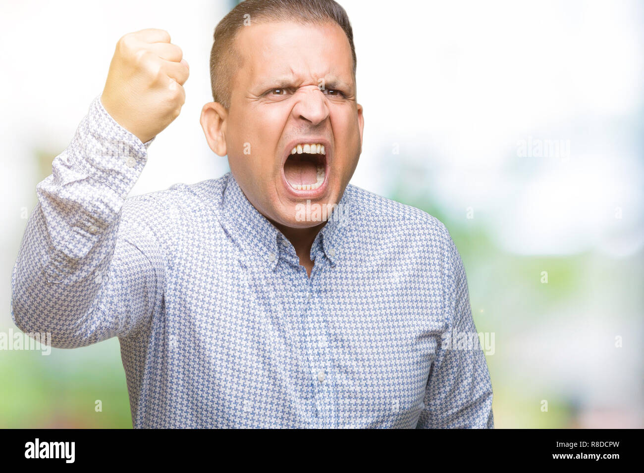 Middle age arab business man over isolated background angry and mad ...