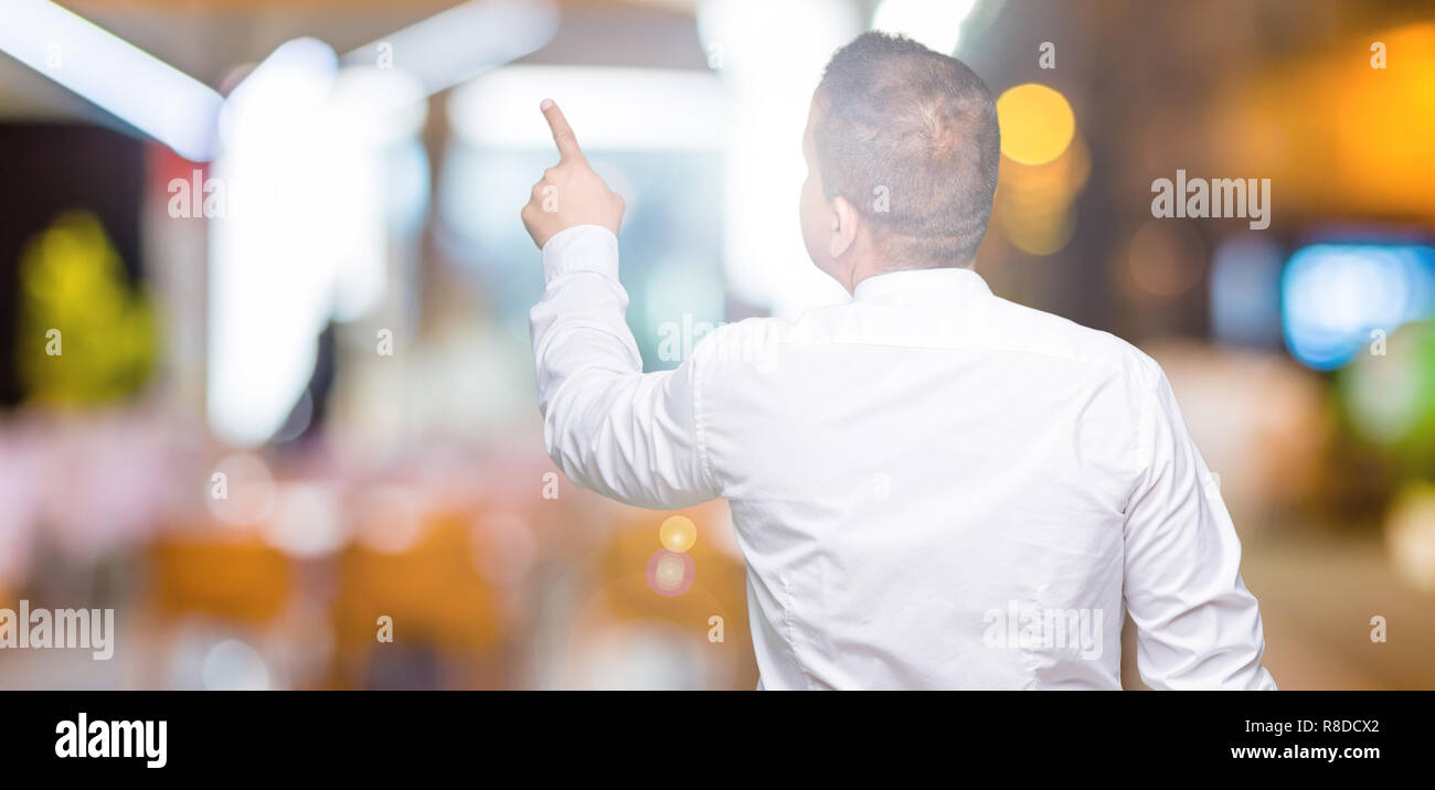 Middle age arab elegant man over isolated background Posing backwards ...
