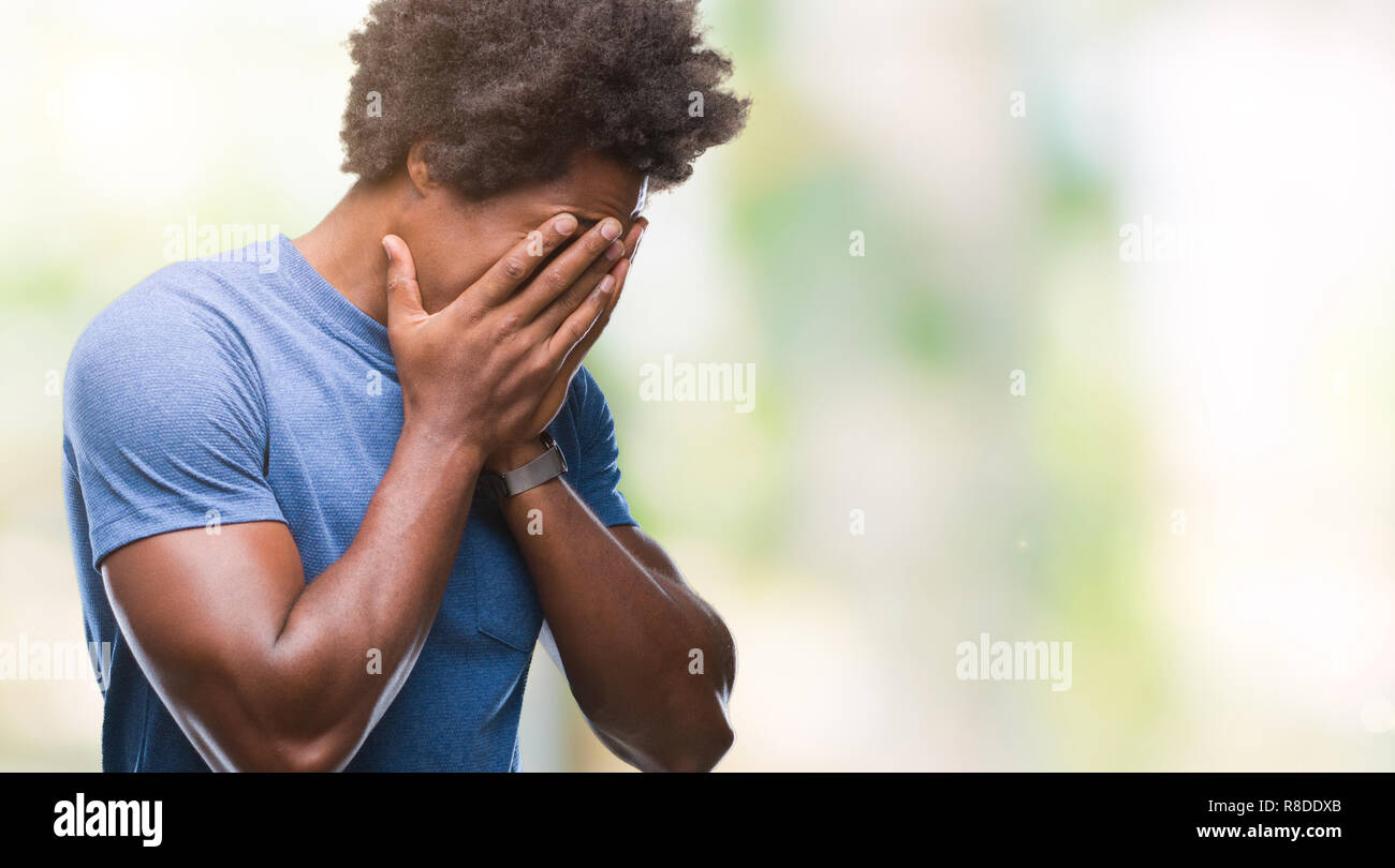 Afro american man over isolated background with sad expression covering ...