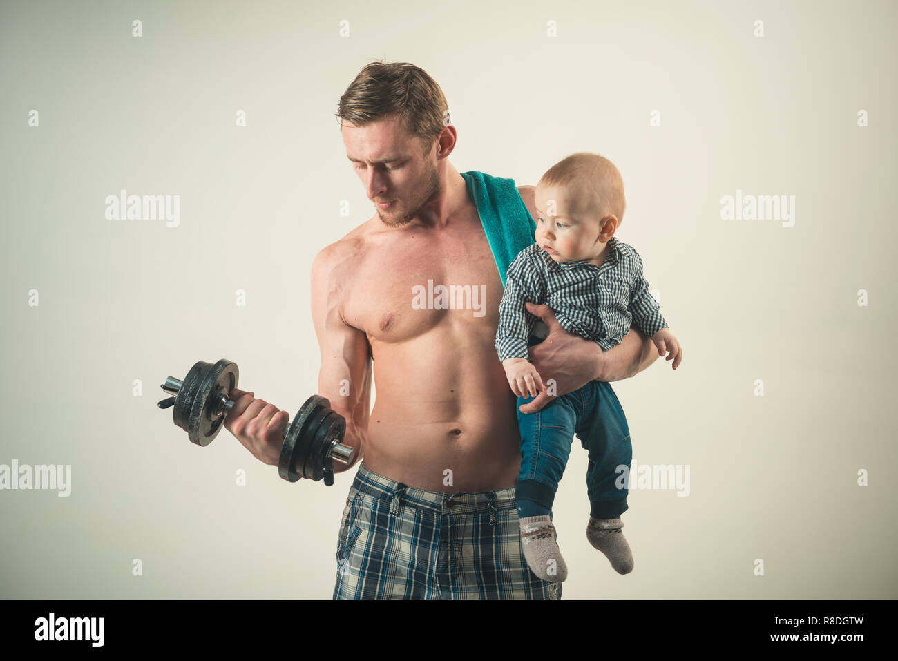 Sport and leisure. Father build biceps triceps with son. Father and ...