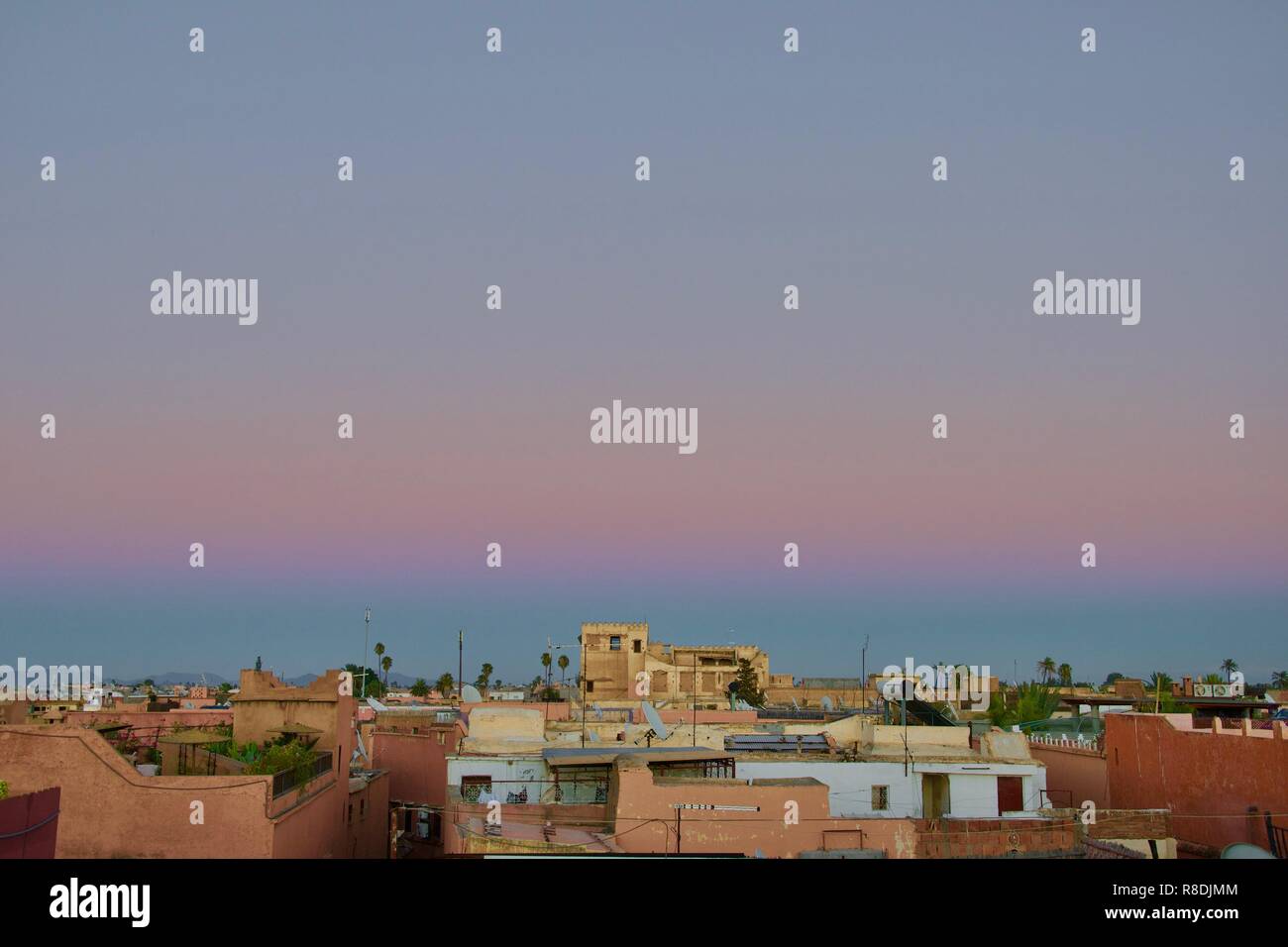 The early stages of a sunset in Marrakech - the sky turns purple and ...