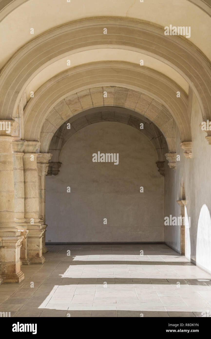 Beautiful corridor with arched ceilings, stone pillars and shadows, at ...