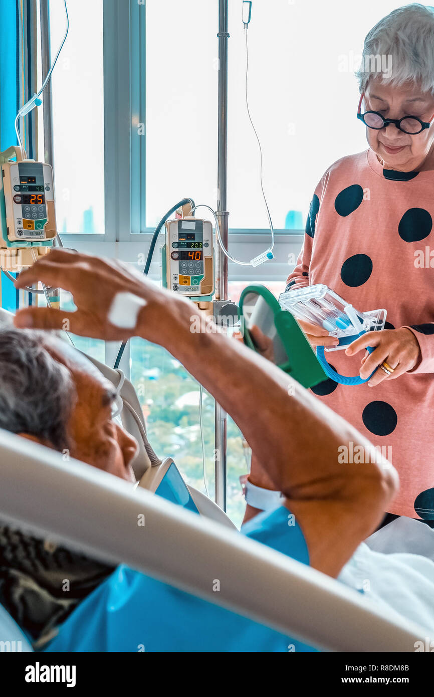 Elderly patients relax in hospital bed Stock Photo - Alamy