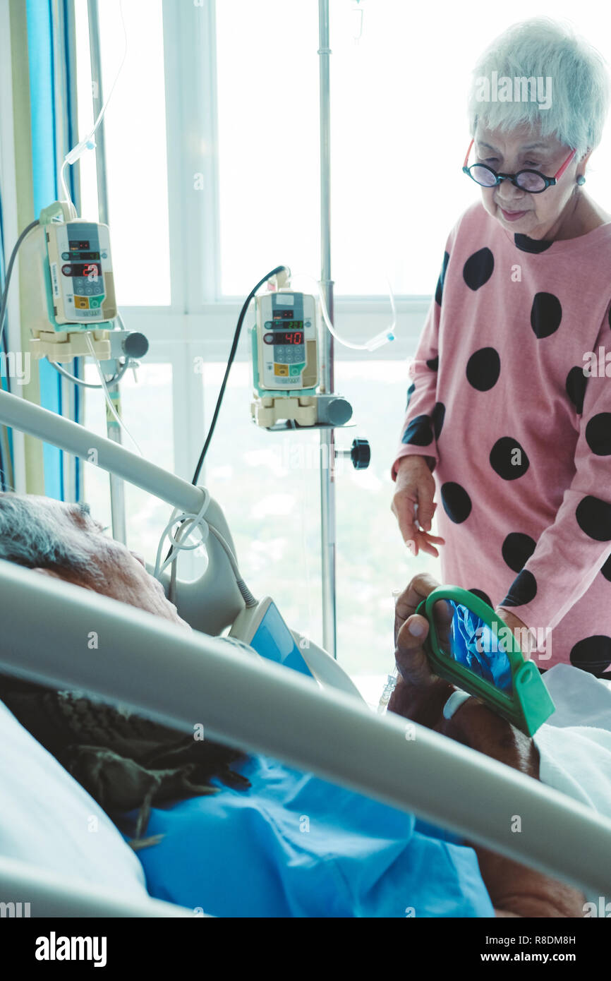 Elderly patients relax in hospital bed Stock Photo - Alamy