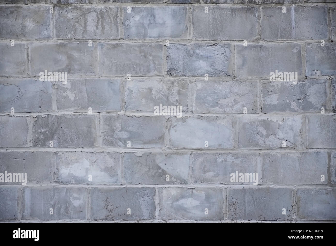 Weathered stained old block wall background. Texture of an old wall of ...