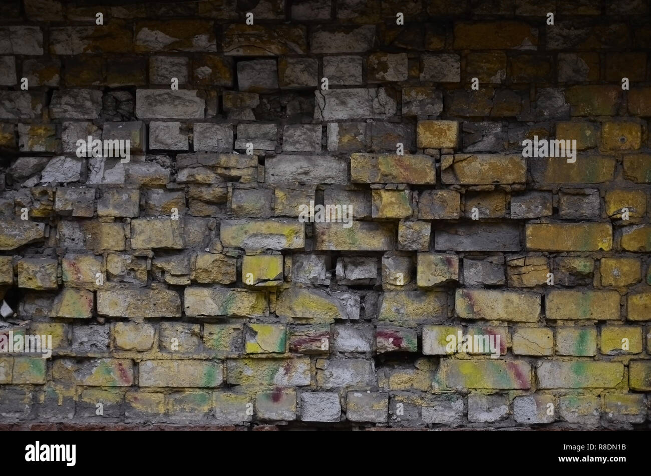 Weathered stained old block wall background. Texture of an old wall of ...