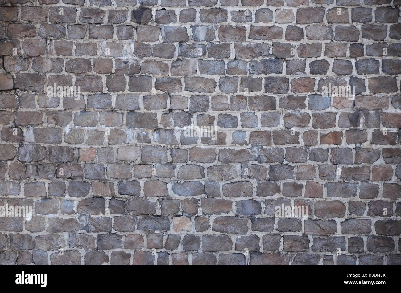Weathered stained old block wall background. Texture of an old wall of ...