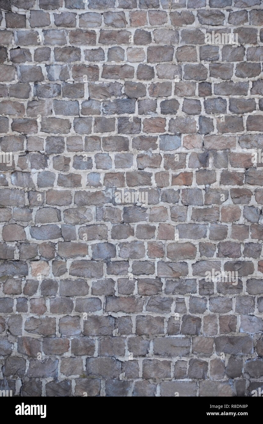 Weathered stained old block wall background. Texture of an old wall of ...