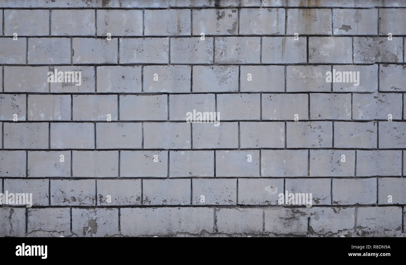 Weathered stained old block wall background. Texture of an old wall of ...