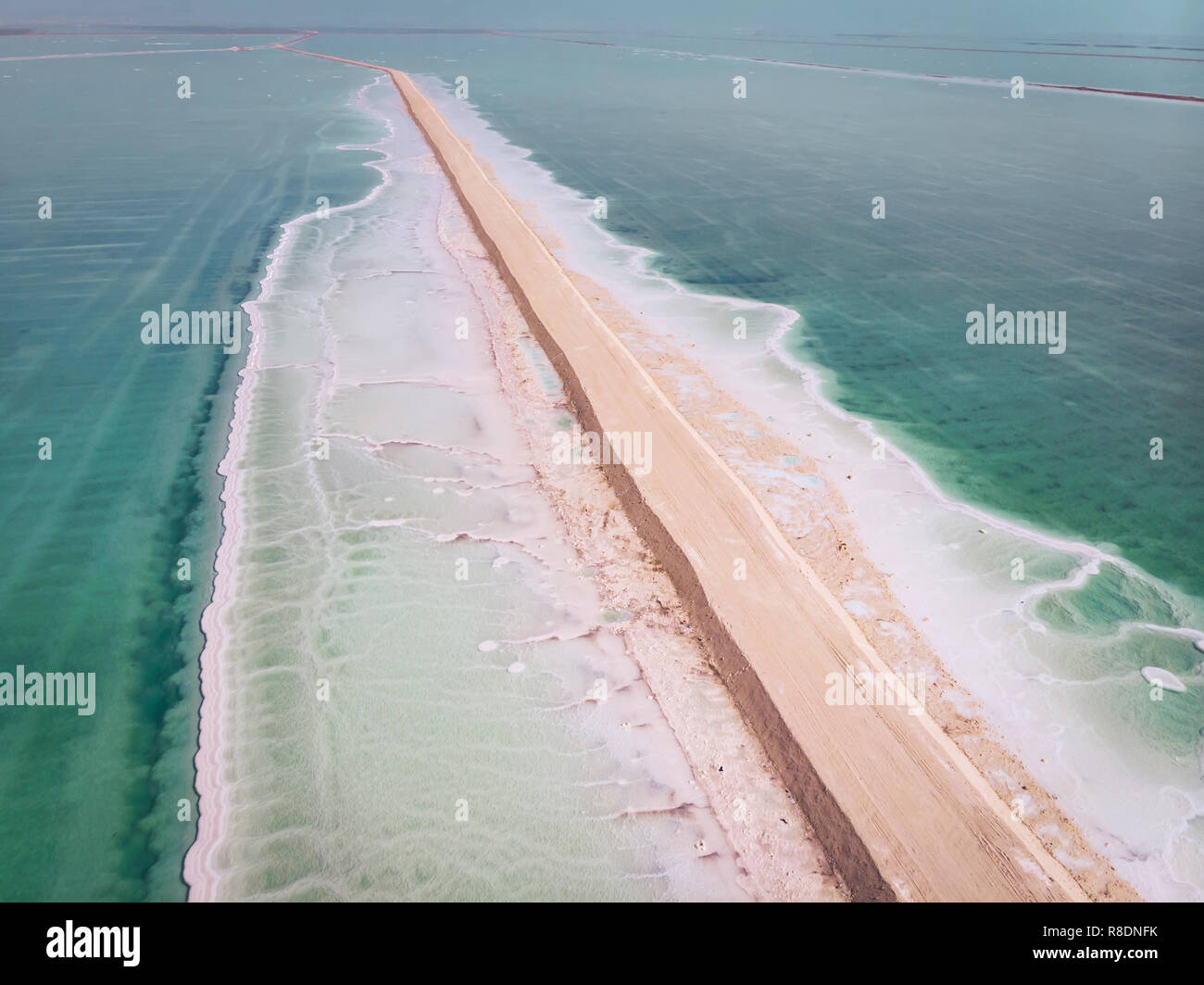 Road on Dead Sea surface. The southern part of the Dead Sea, is divided ...