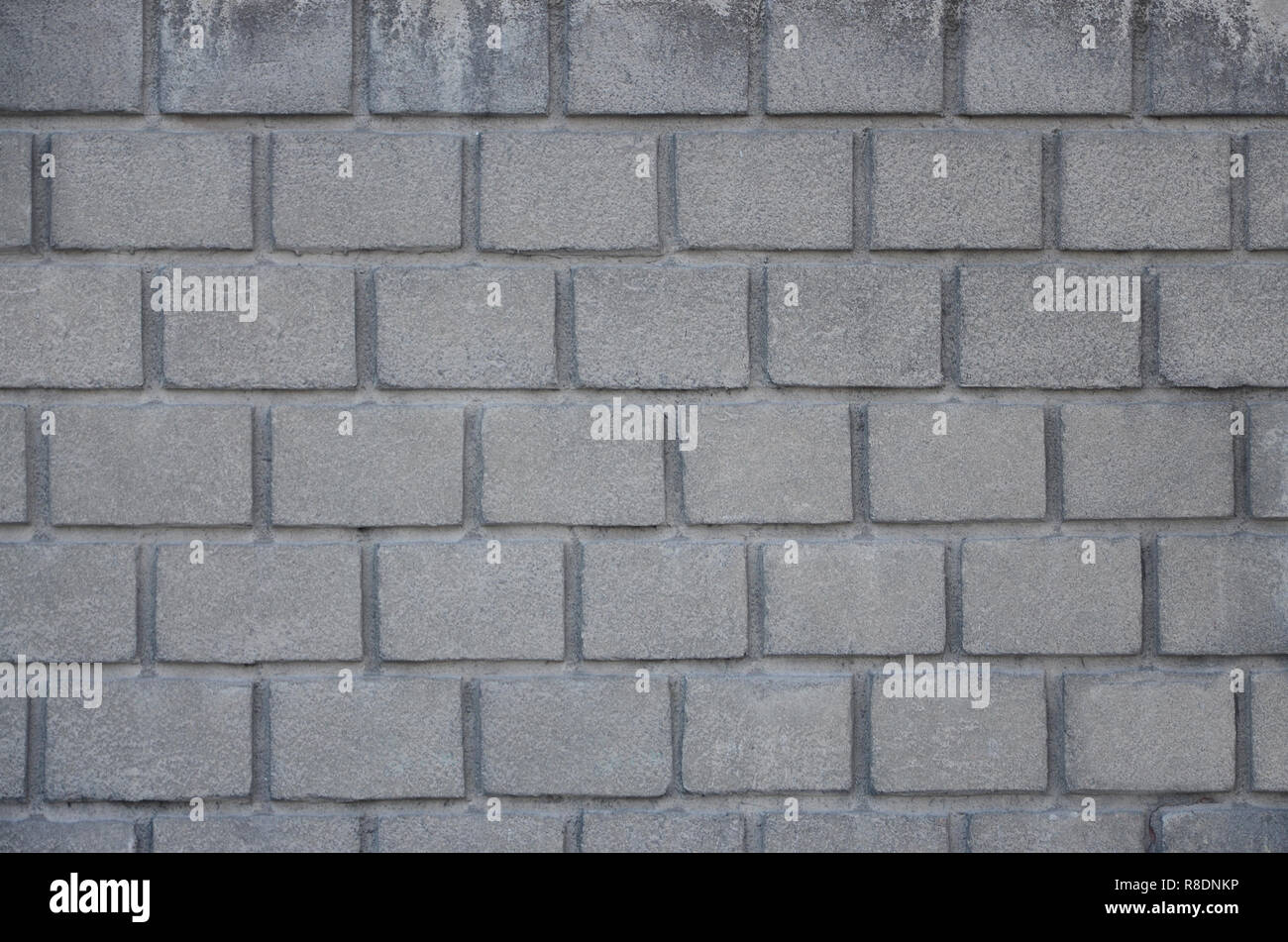 Weathered stained old block wall background. Texture of an old wall of ...